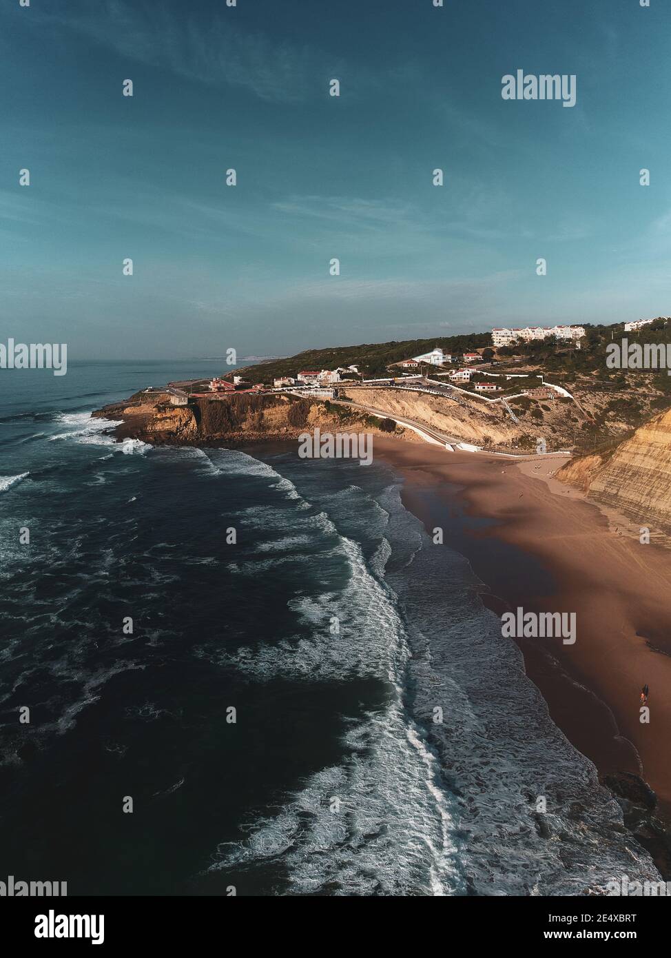 Aerial view of waves on a beautiful sandy ocean beach and cliff ...