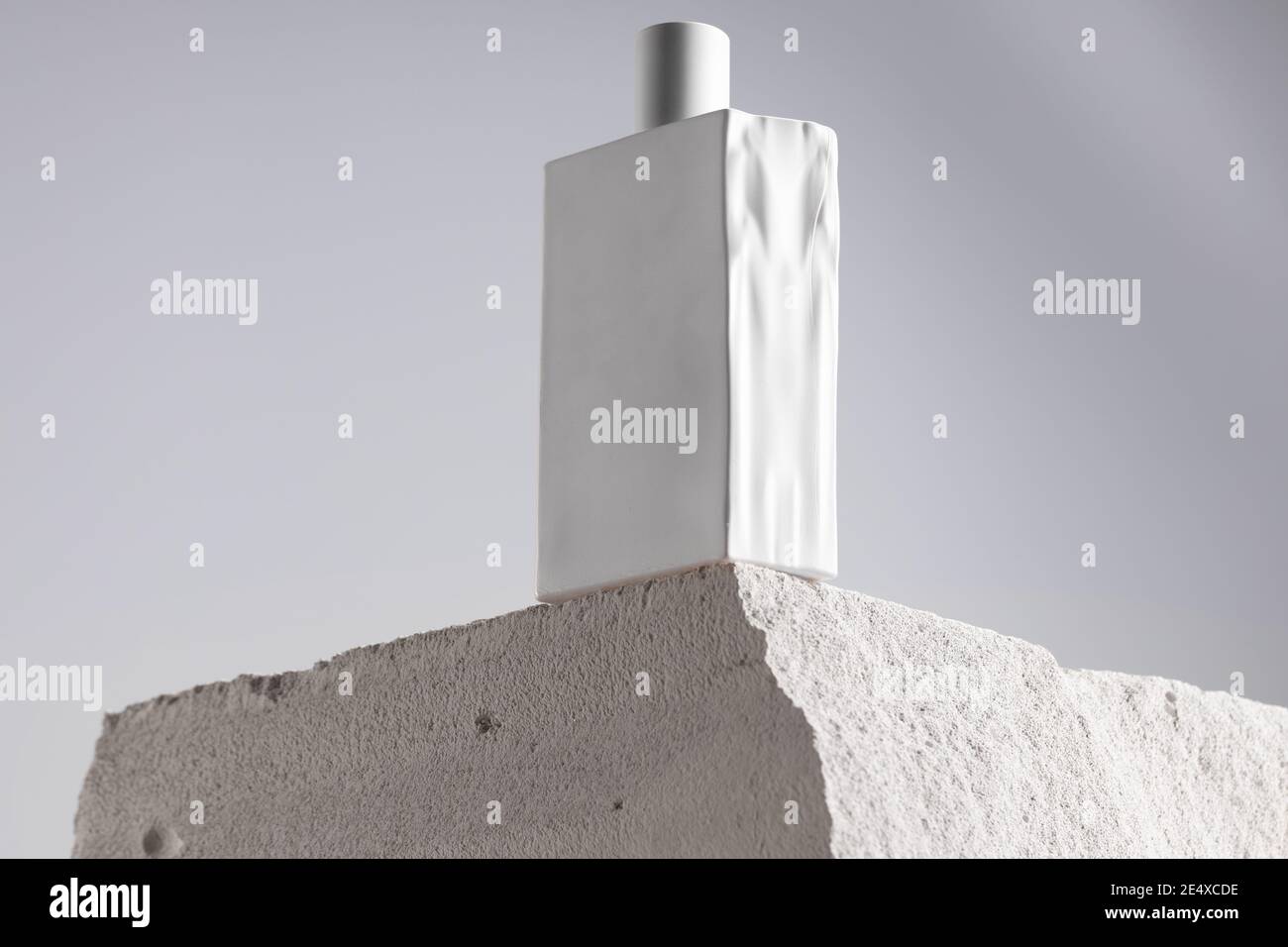 Bottle of perfume on cinder block close up Stock Photo - Alamy