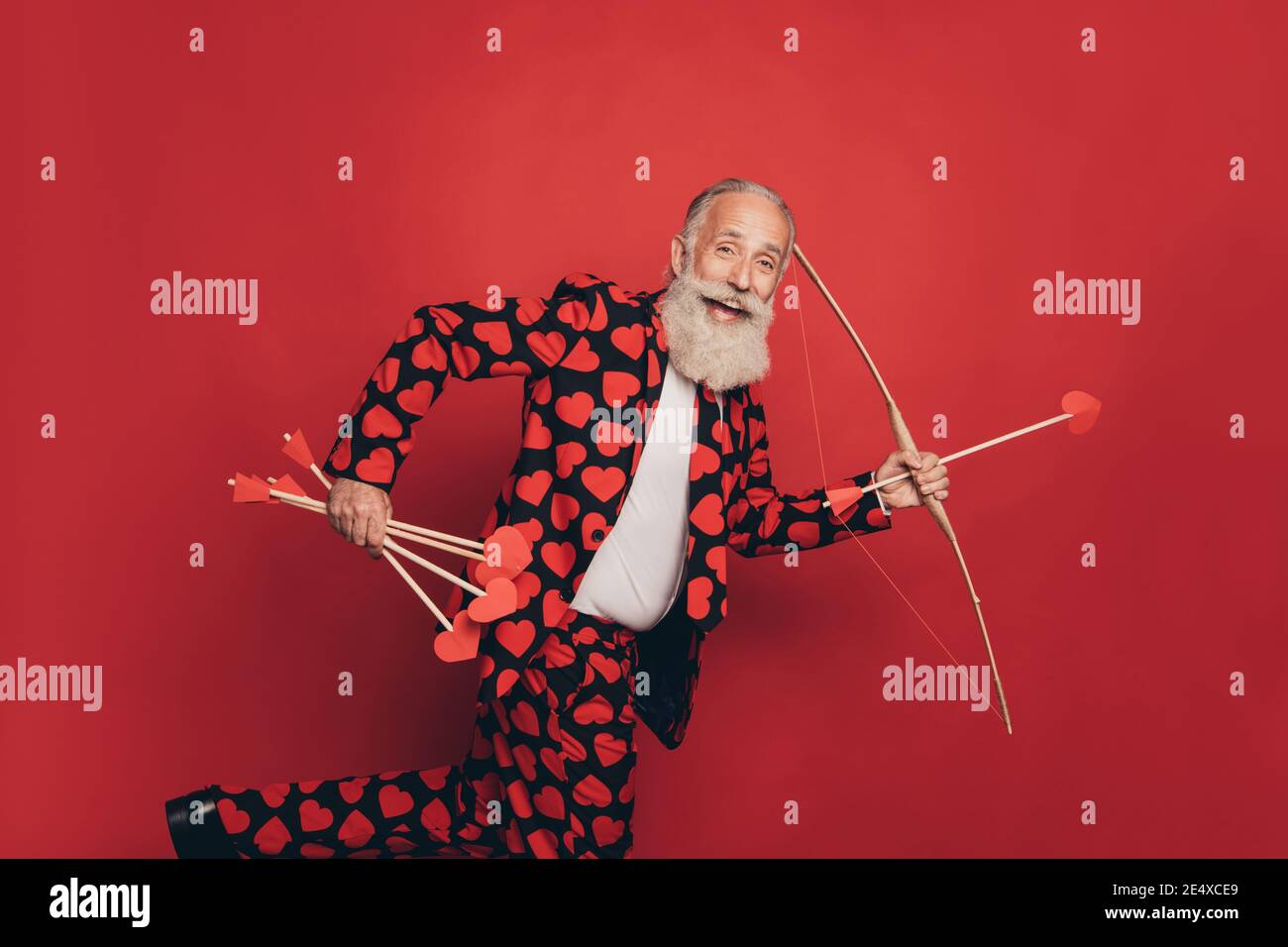 Photo of funky old man hold arrows bow run fast open mouth wear heart ...