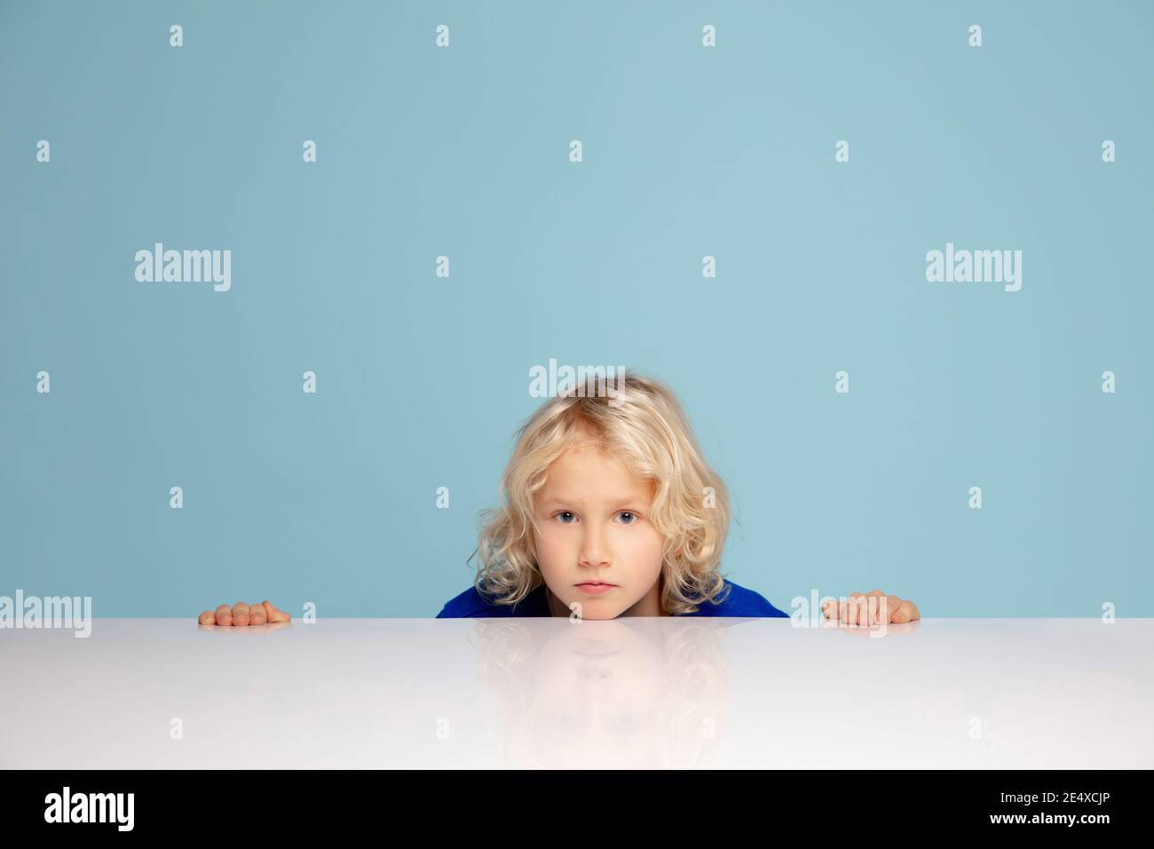 Boy peeking table hi-res stock photography and images - Alamy