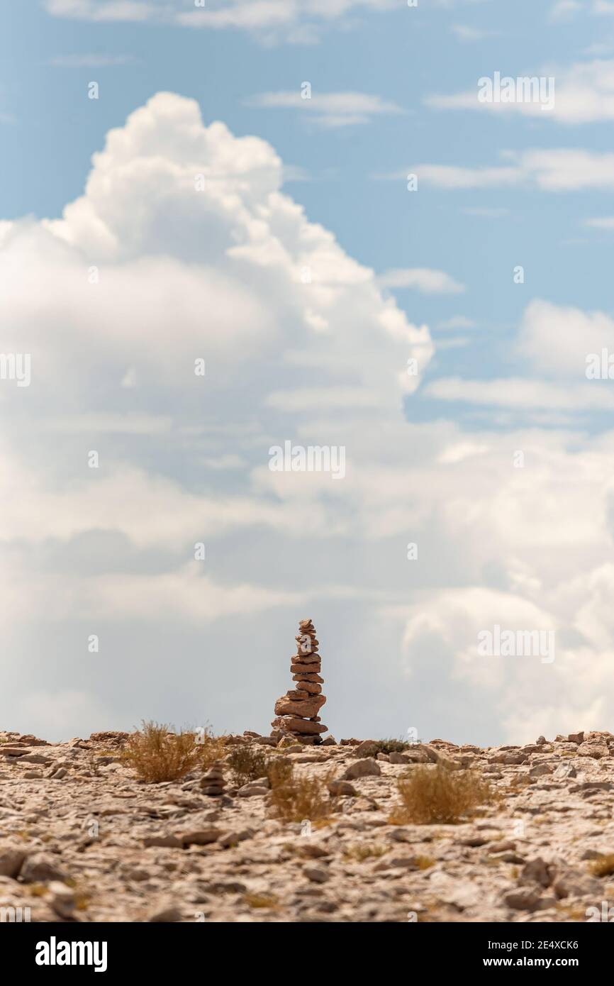 Stone stacks located against rocky formations and cloudy sky in Atacama ...