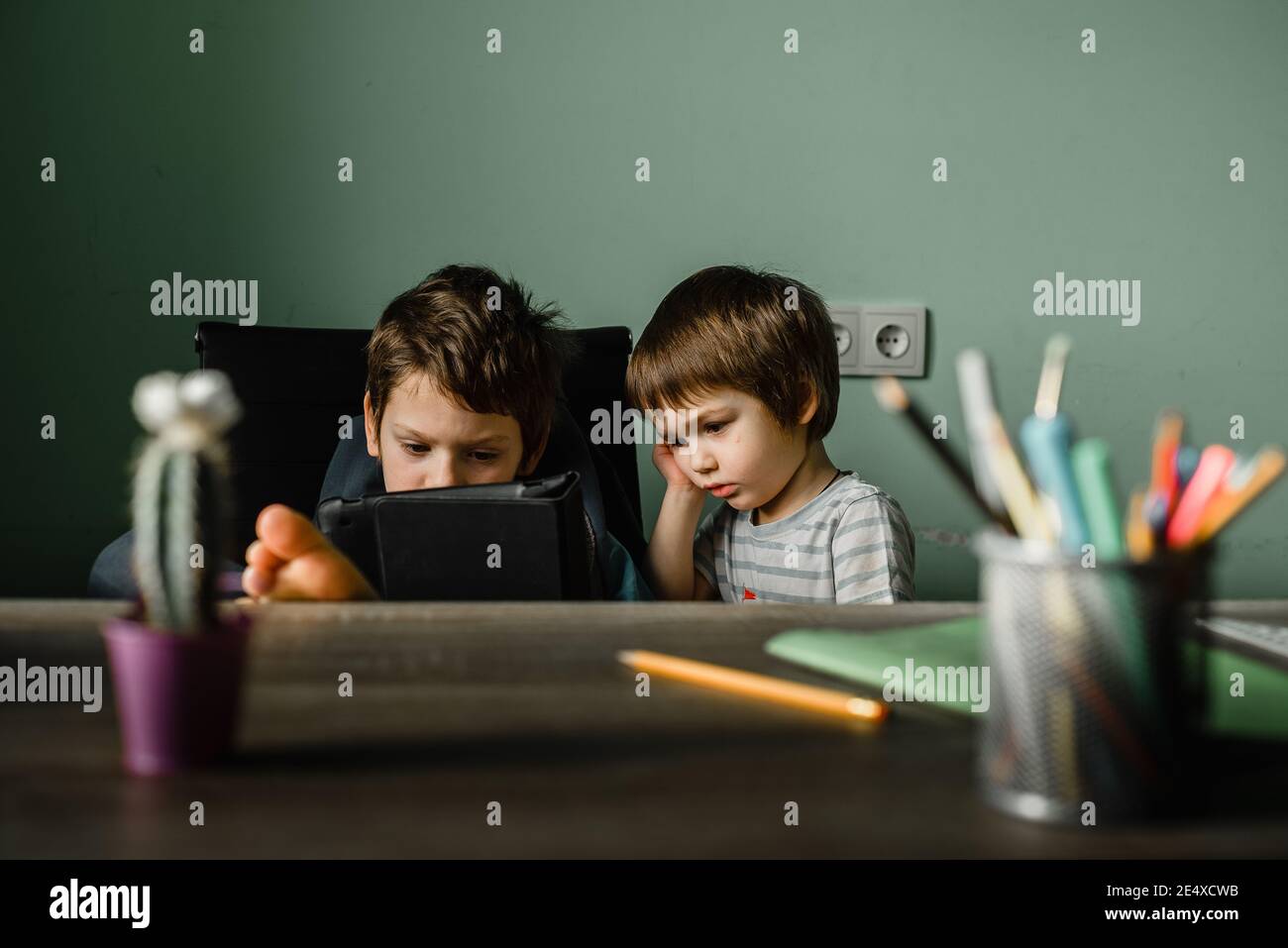 Children playing tablet at home, growing up with technology Stock Photo ...