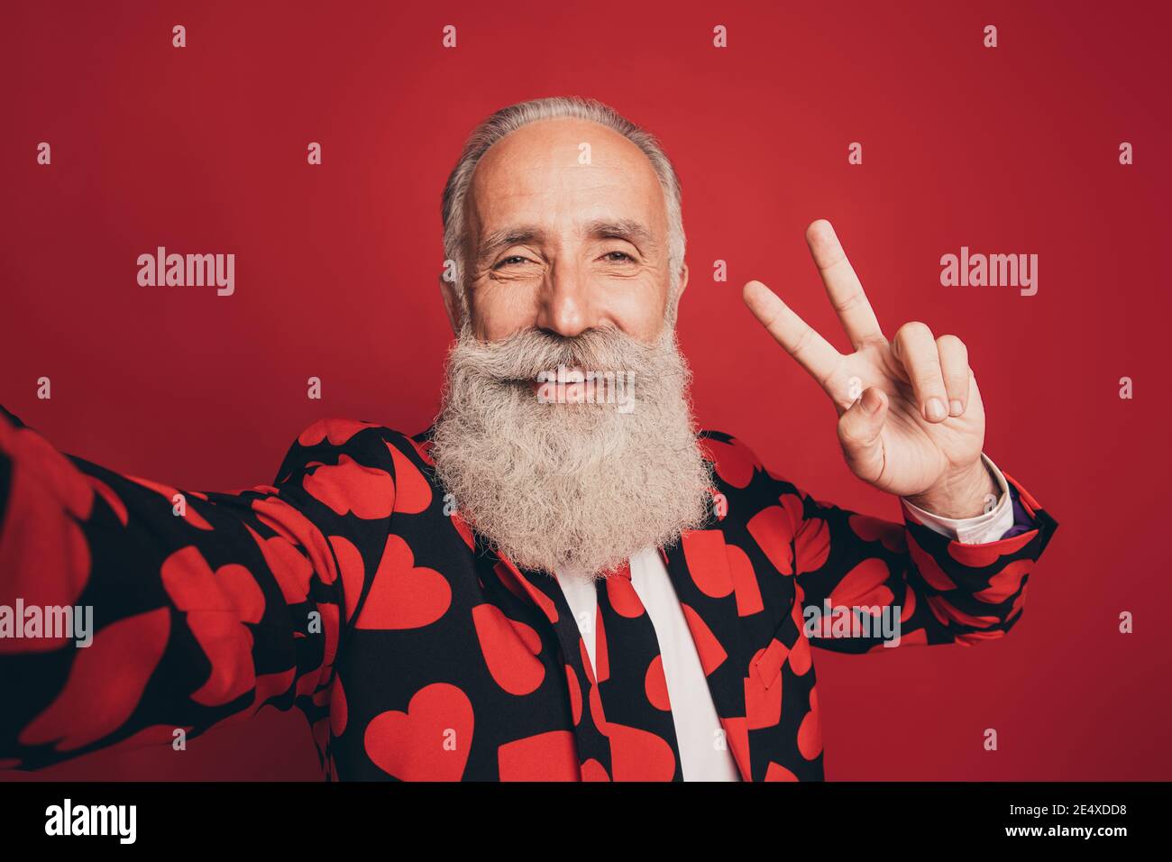 Photo Of Funny Old Man Take Selfie Show V Sign Toothy Smile Wear Heart