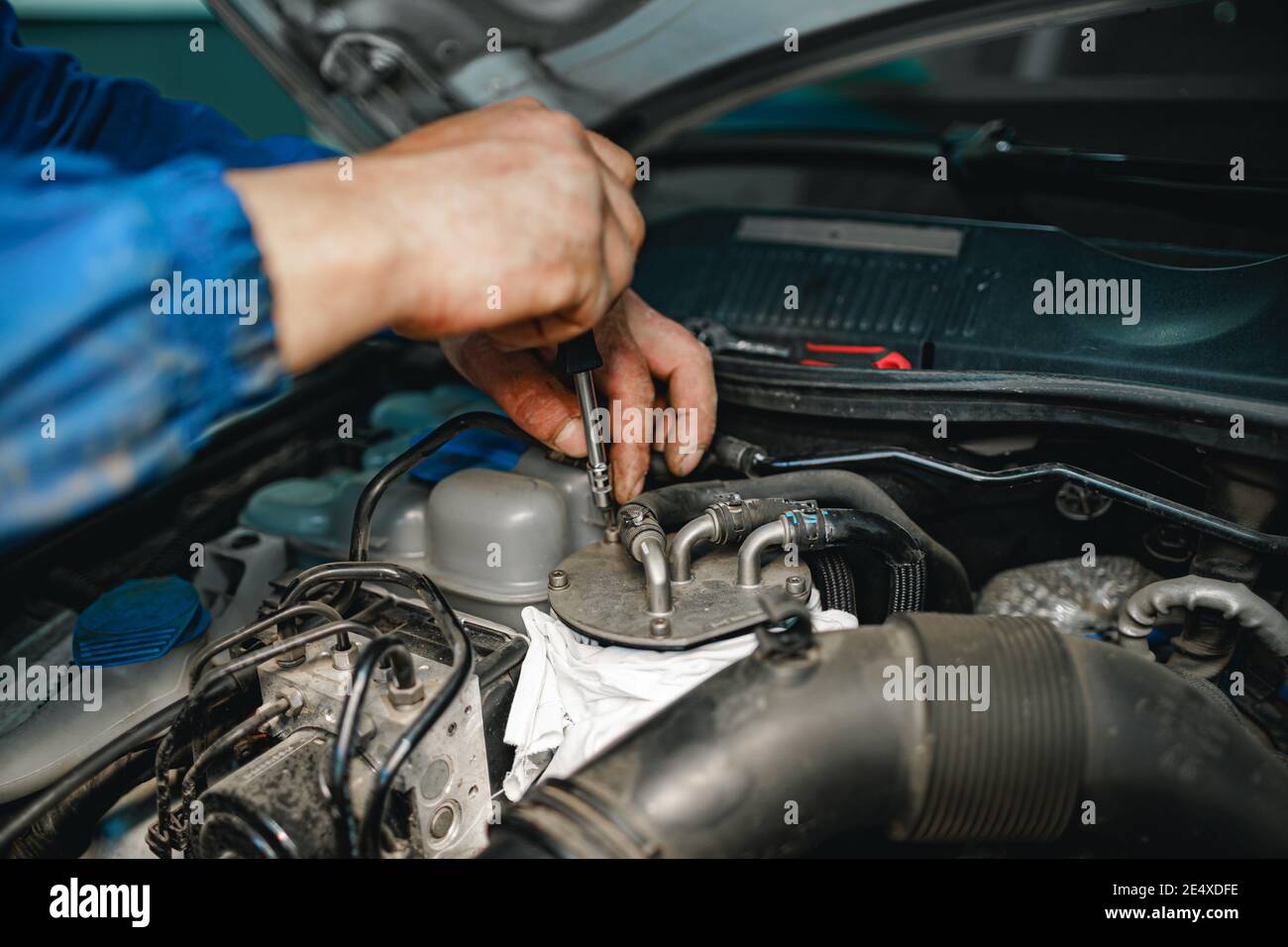 Auto mechanic man checks car engine under the hood Stock Photo - Alamy