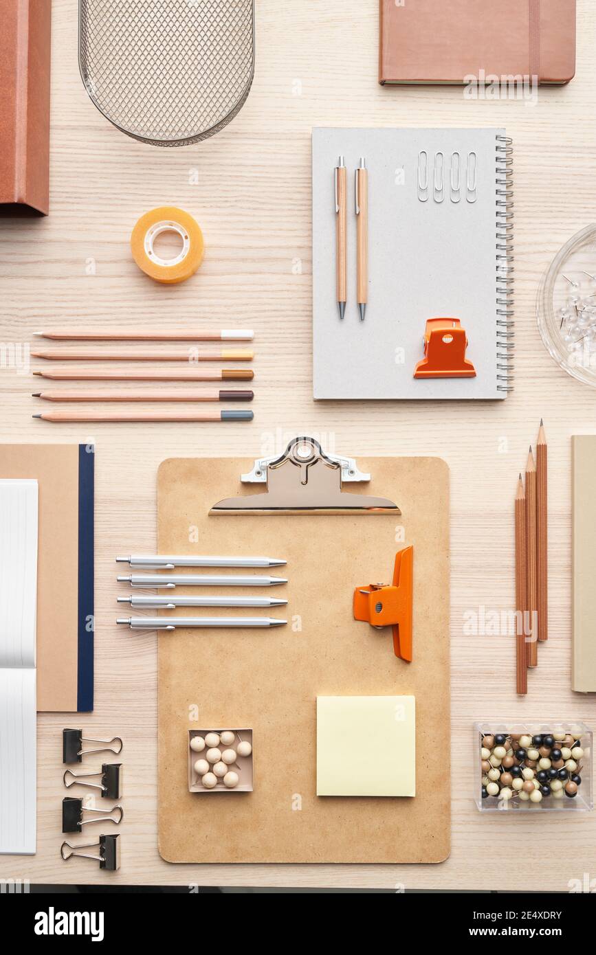 Top view of various modern stationery placed near clipboard and ...
