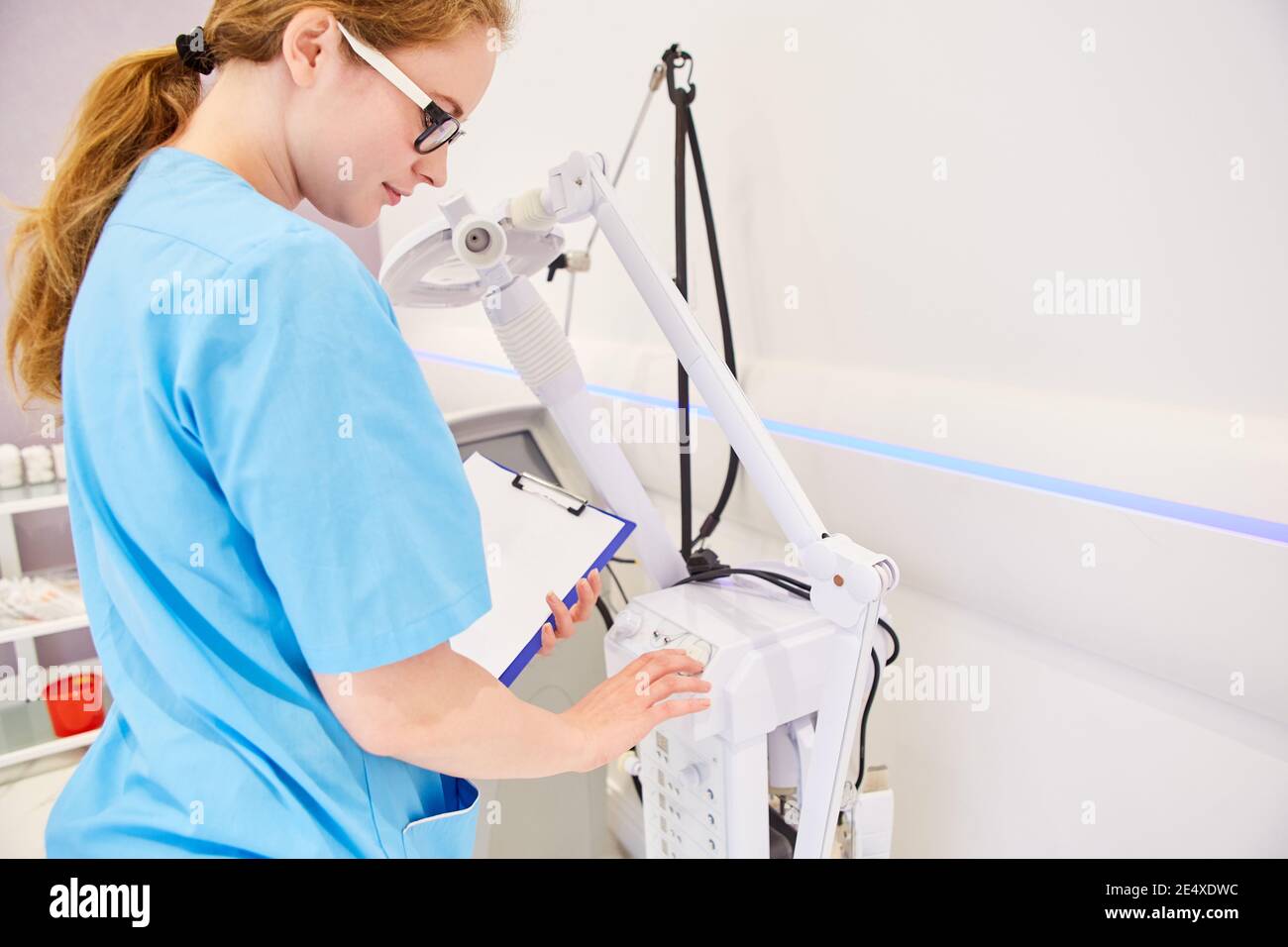 Surgical nurse operates a medical device in a hospital or doctor's ...
