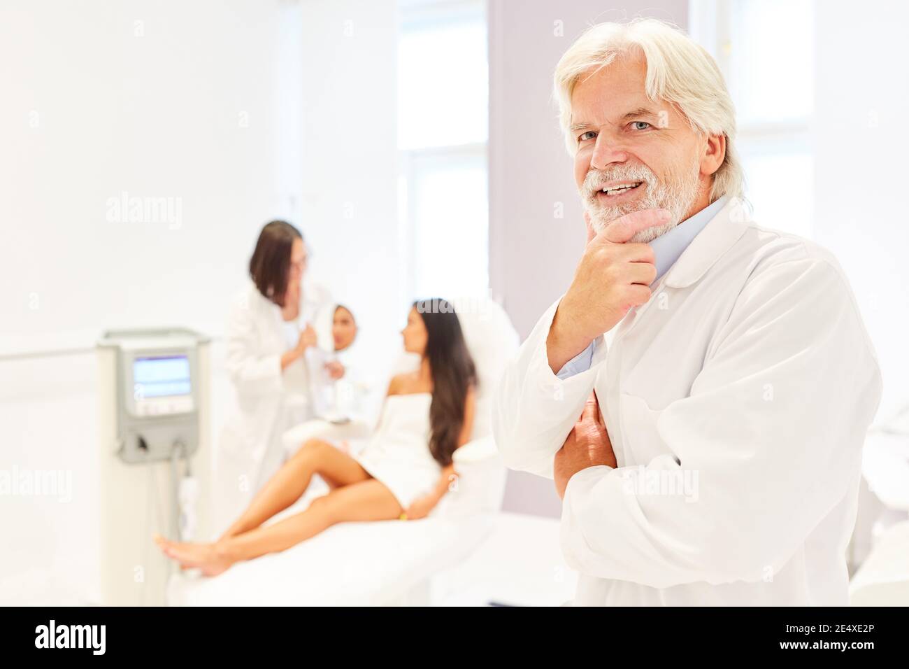 Doctor as smiling plastic surgery specialist in the beauty clinic Stock ...