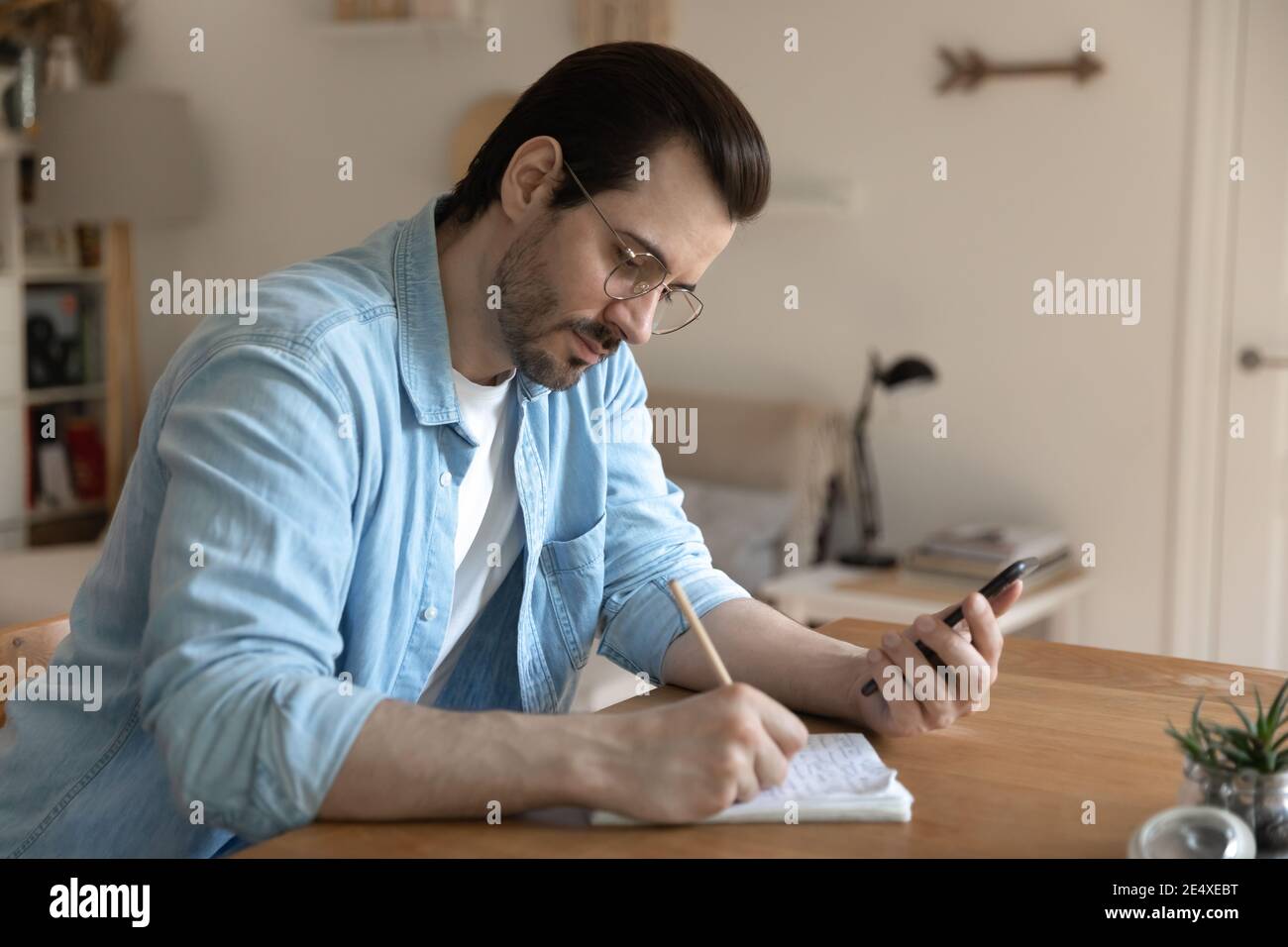 Man watching watch writing paper hi-res stock photography and images ...