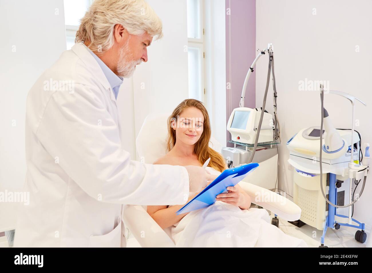 Doctor and woman with treatment contract providing patient information ...