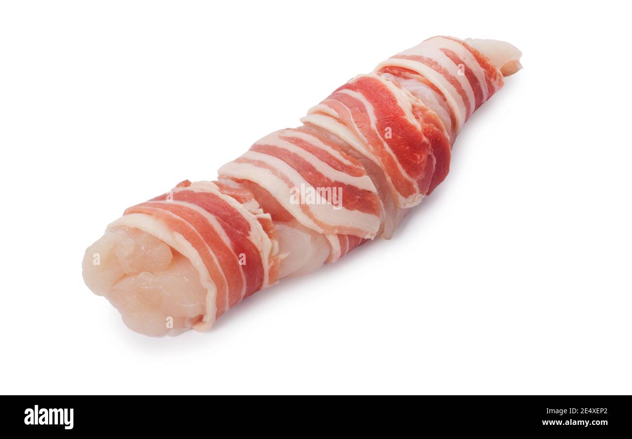 Studio shot of monkfish tail wrapped in streaky bacon cut out against a ...