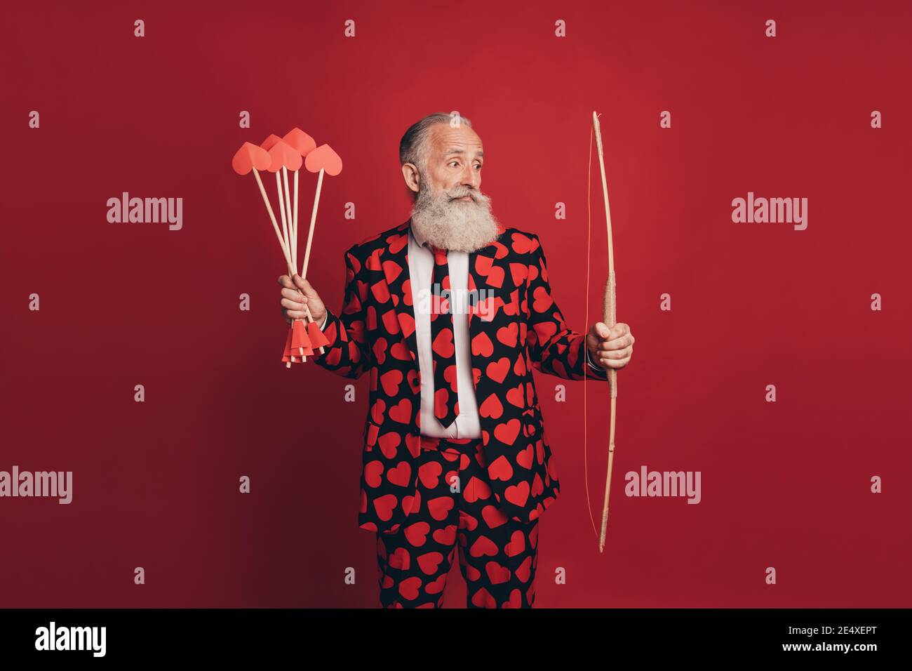 Photo of confused old cupid man hold bow arrow look shrug look side ...