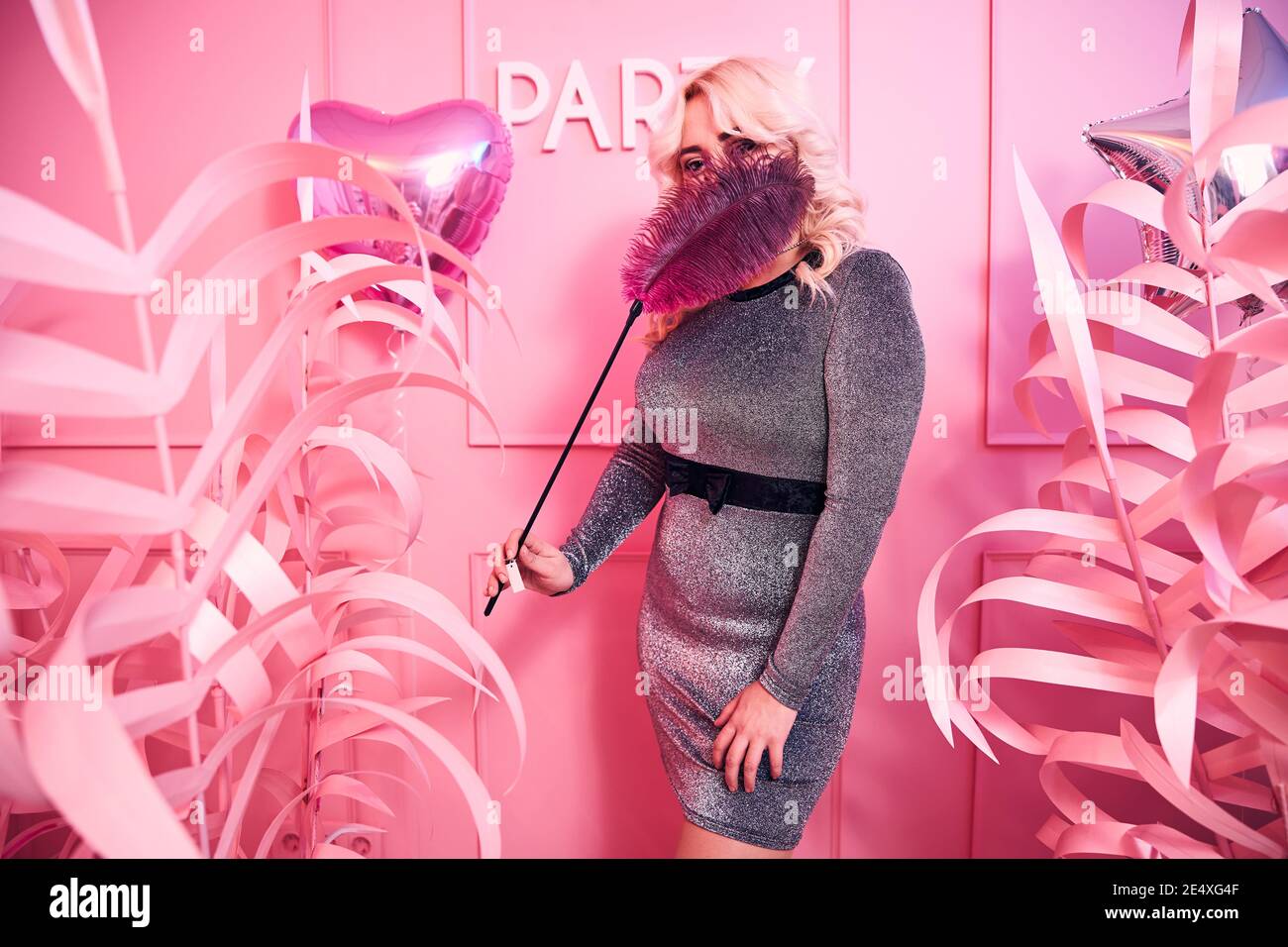 Female covering her visage with an artificial ostrich feather Stock ...
