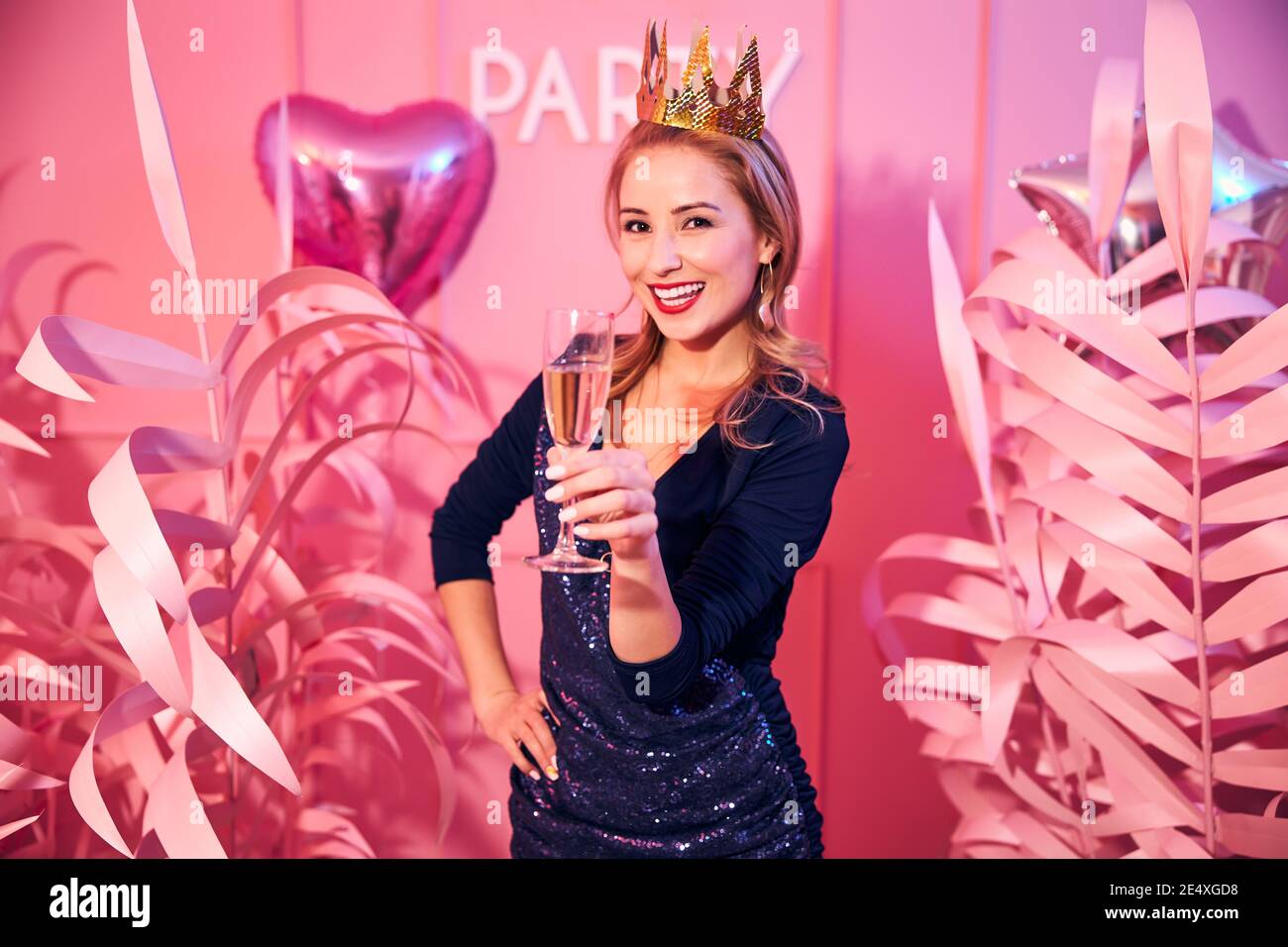 High-spirited lady with a glass of champagne looking ahead Stock Photo ...