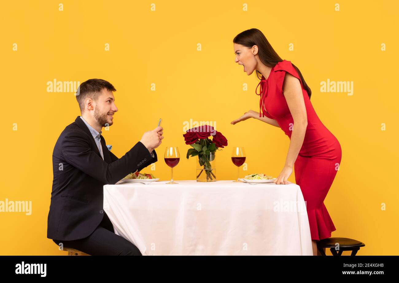 Boyfriend Using Phone Ignoring Girlfriend Shouting At Him, Yellow ...