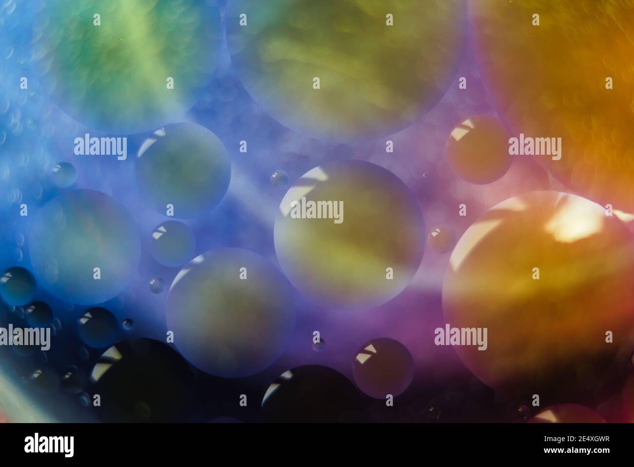 Blurred soft focus of oil spheres in water with color transition from ...