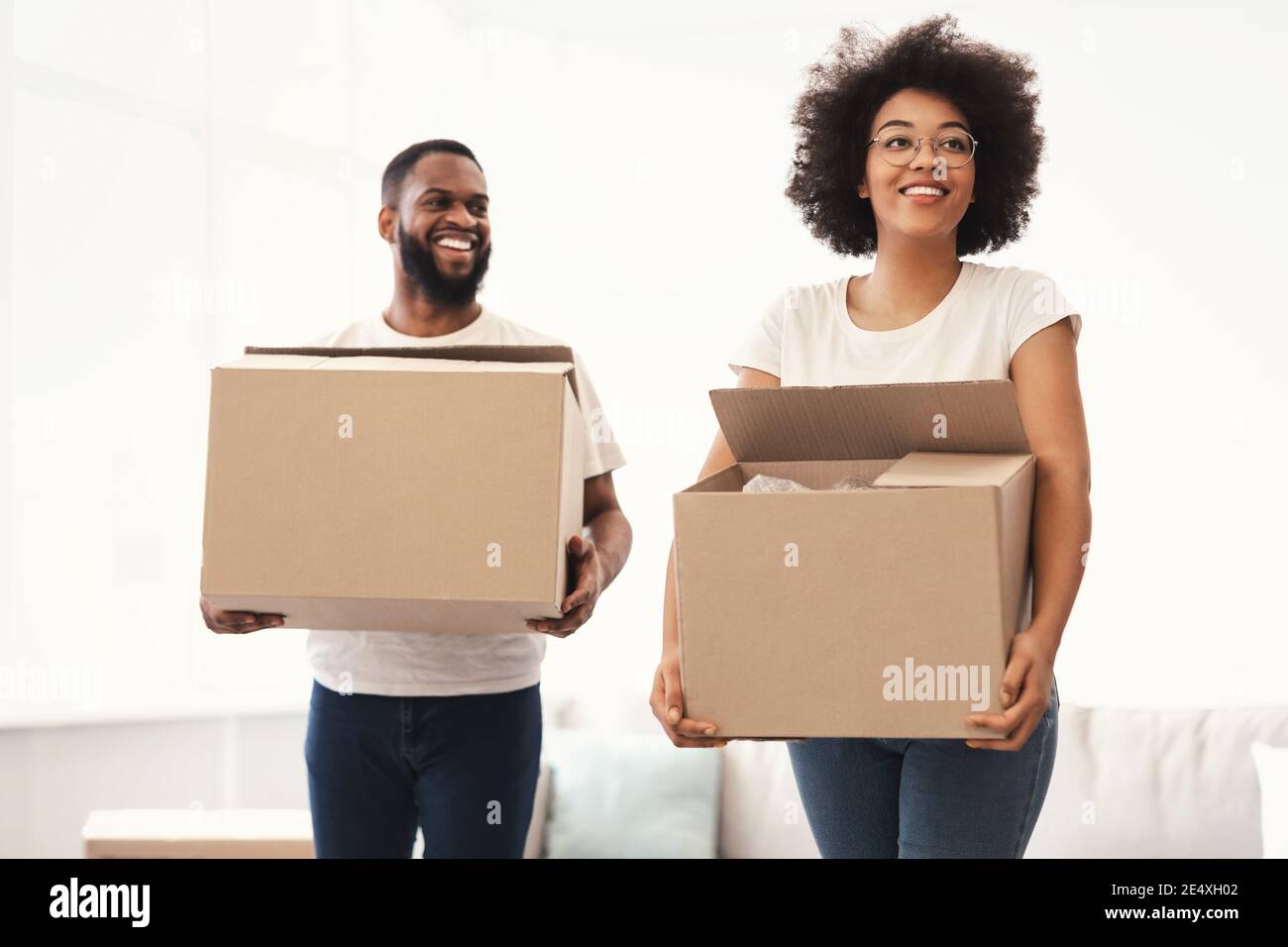 African American Spouses Carrying Moving Boxes Into New House Stock ...