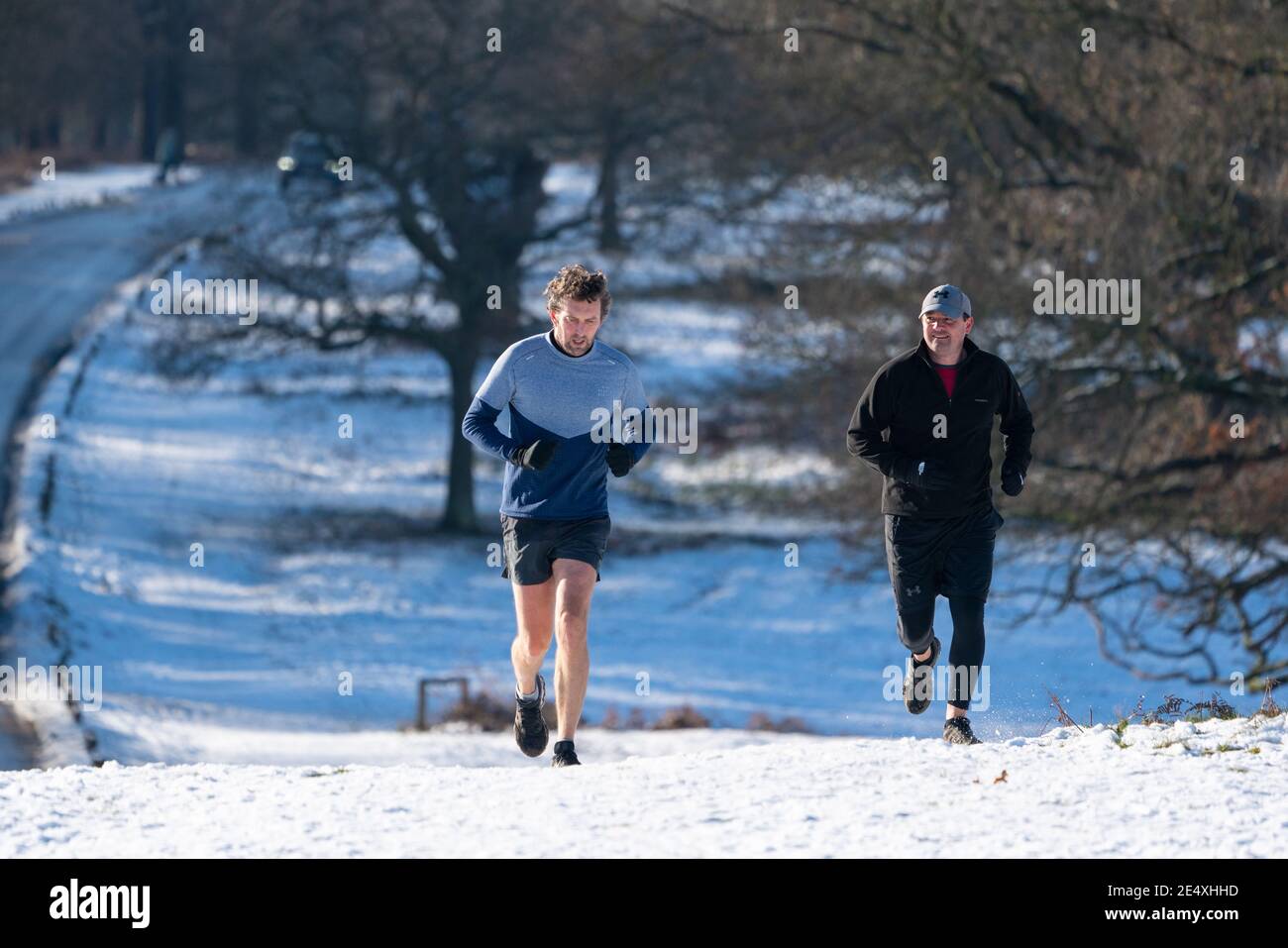 Runners make their way through the snow in Richmond Park, London ...