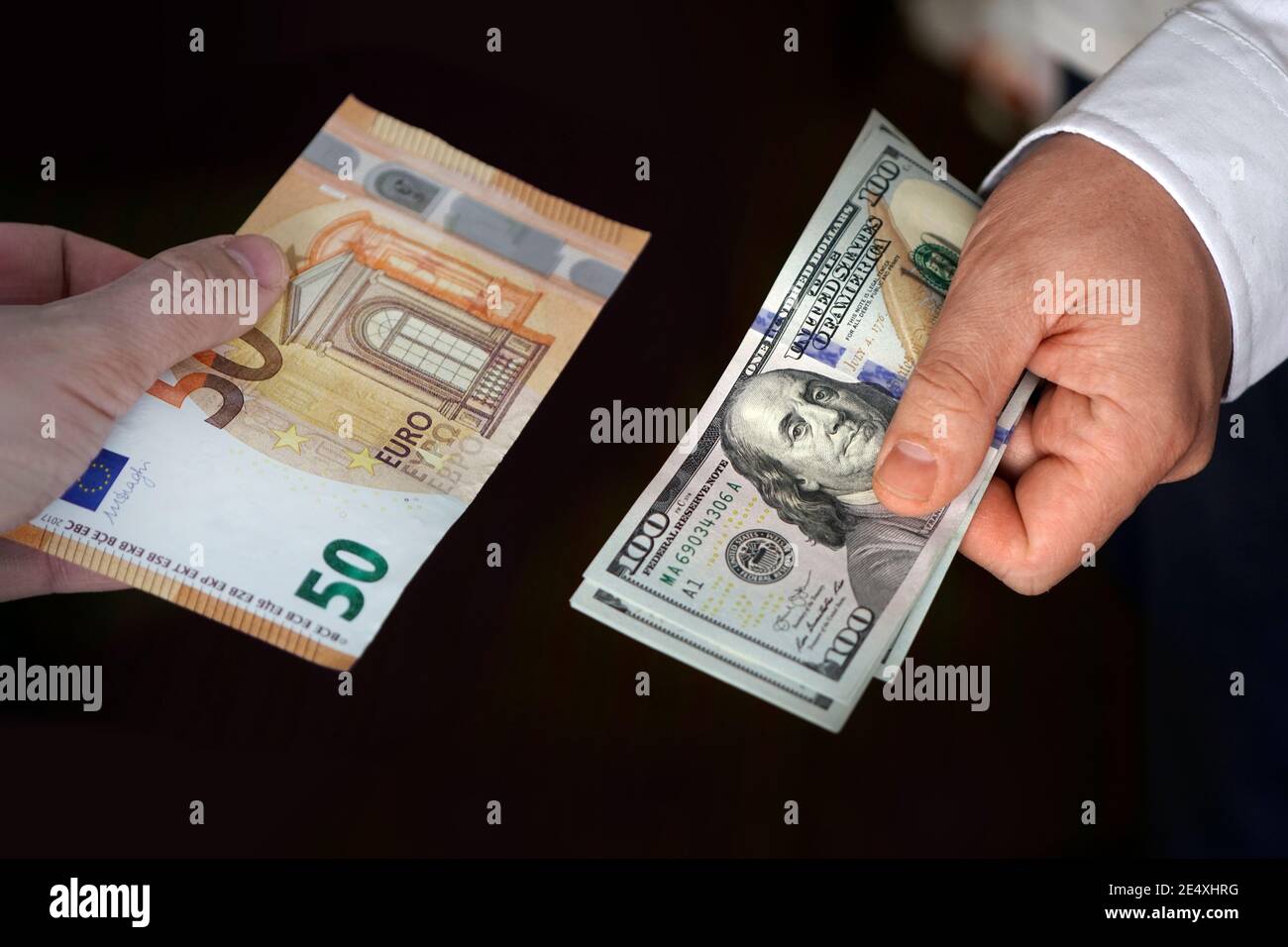 women hands exchanging European banknotes and American dollar money ... women hands exchanging European banknotes and American dollar money ...