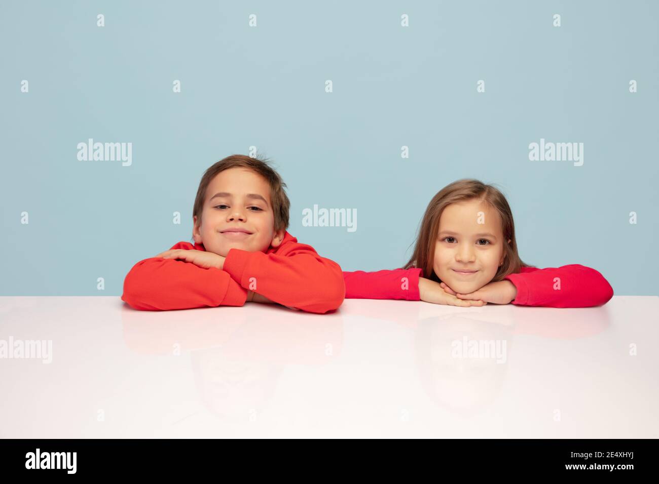 Sincere. Happy children isolated on blue studio background. Look happy ...