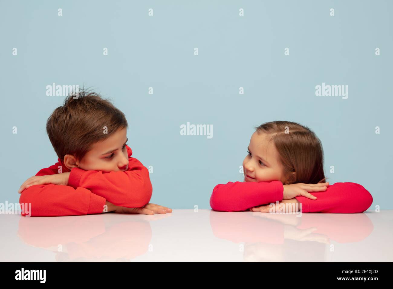 Looking. Happy children isolated on blue studio background. Look happy ...