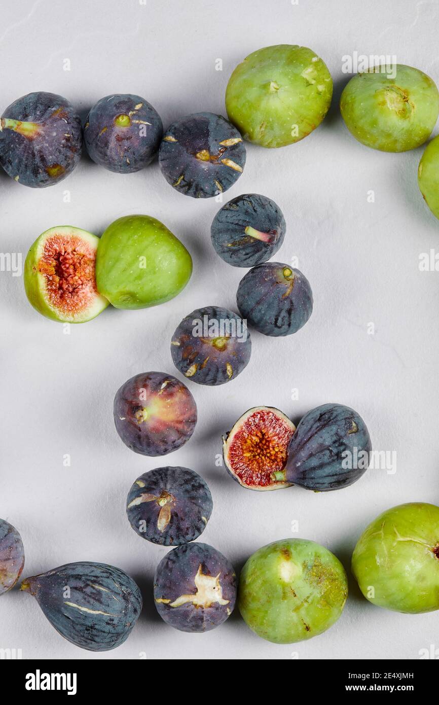 Purple and green figs isolated on white background Stock Photo - Alamy