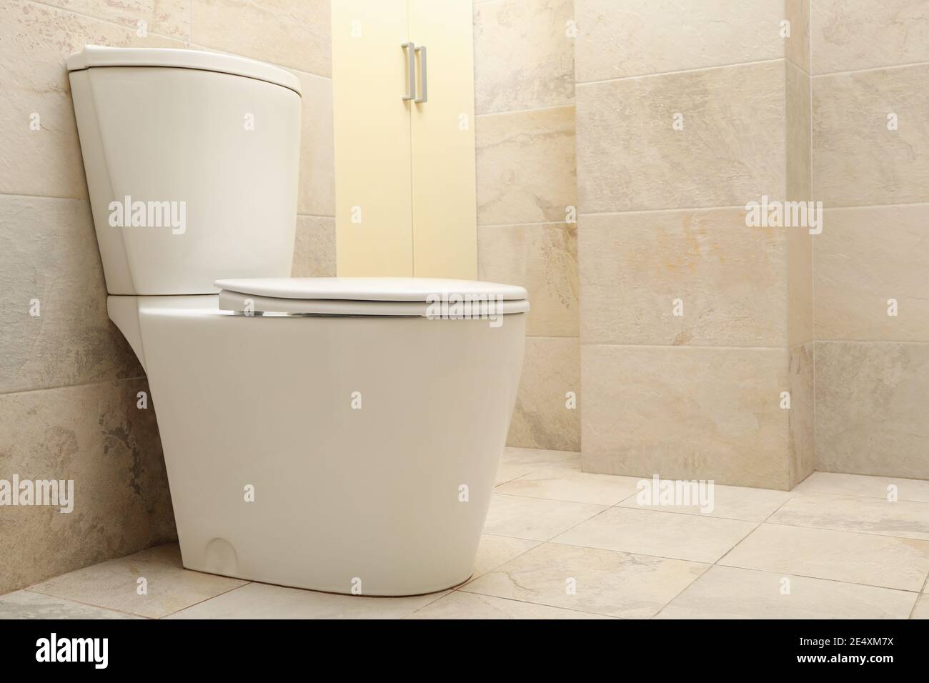 Toilet bowl in modern bathroom in light beige color Stock Photo - Alamy