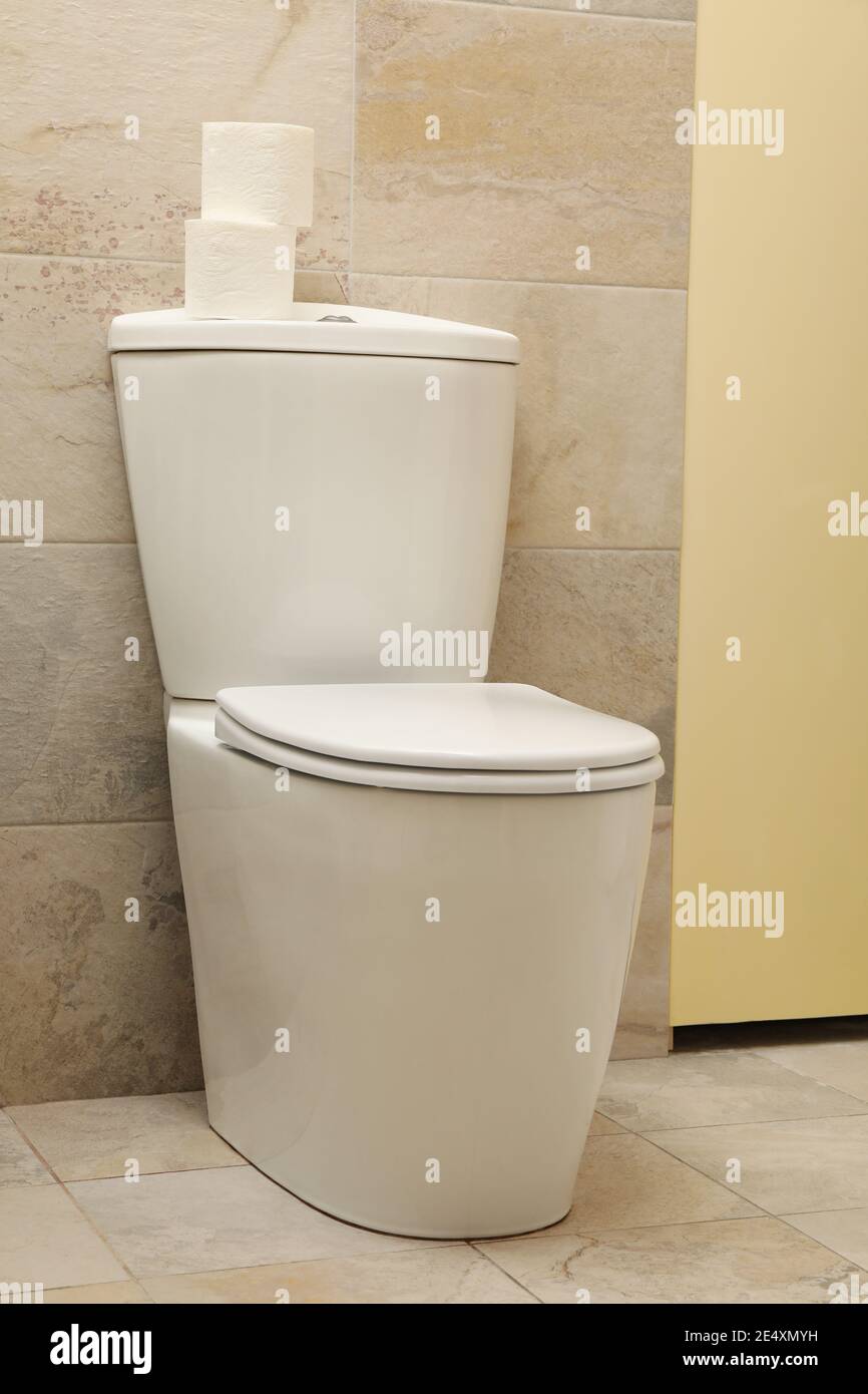 Toilet bowl in modern bathroom in light beige color Stock Photo - Alamy