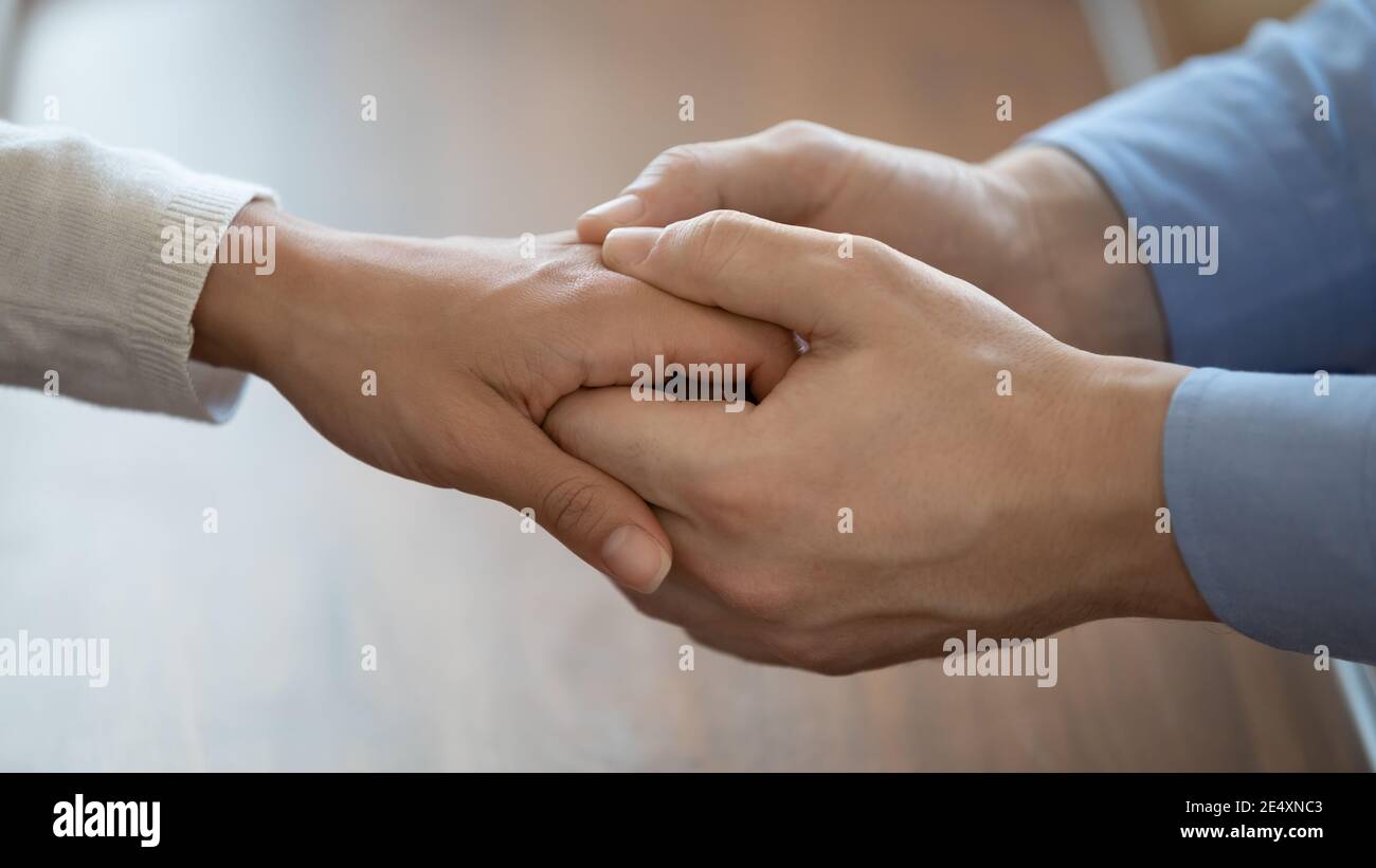 Close up loving man touching woman hand, comforting and supposing Stock ...