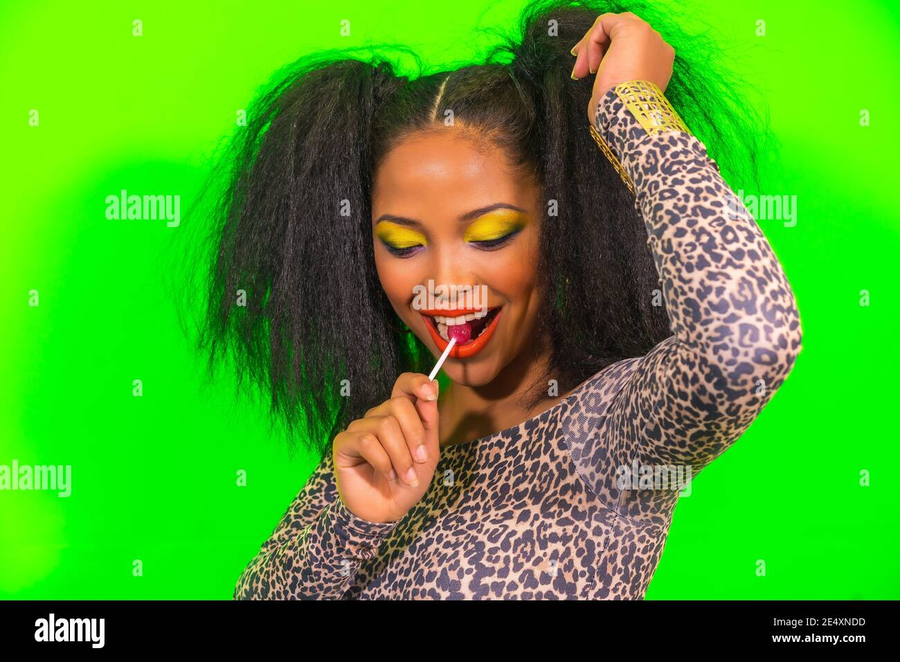 Pretty Hispanic girl with bright makeup and two tails hairstyle posing ...