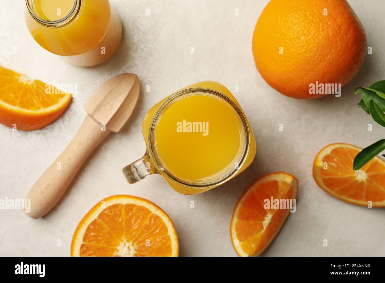 Glass jars with orange juice on white beige background Stock Photo - Alamy