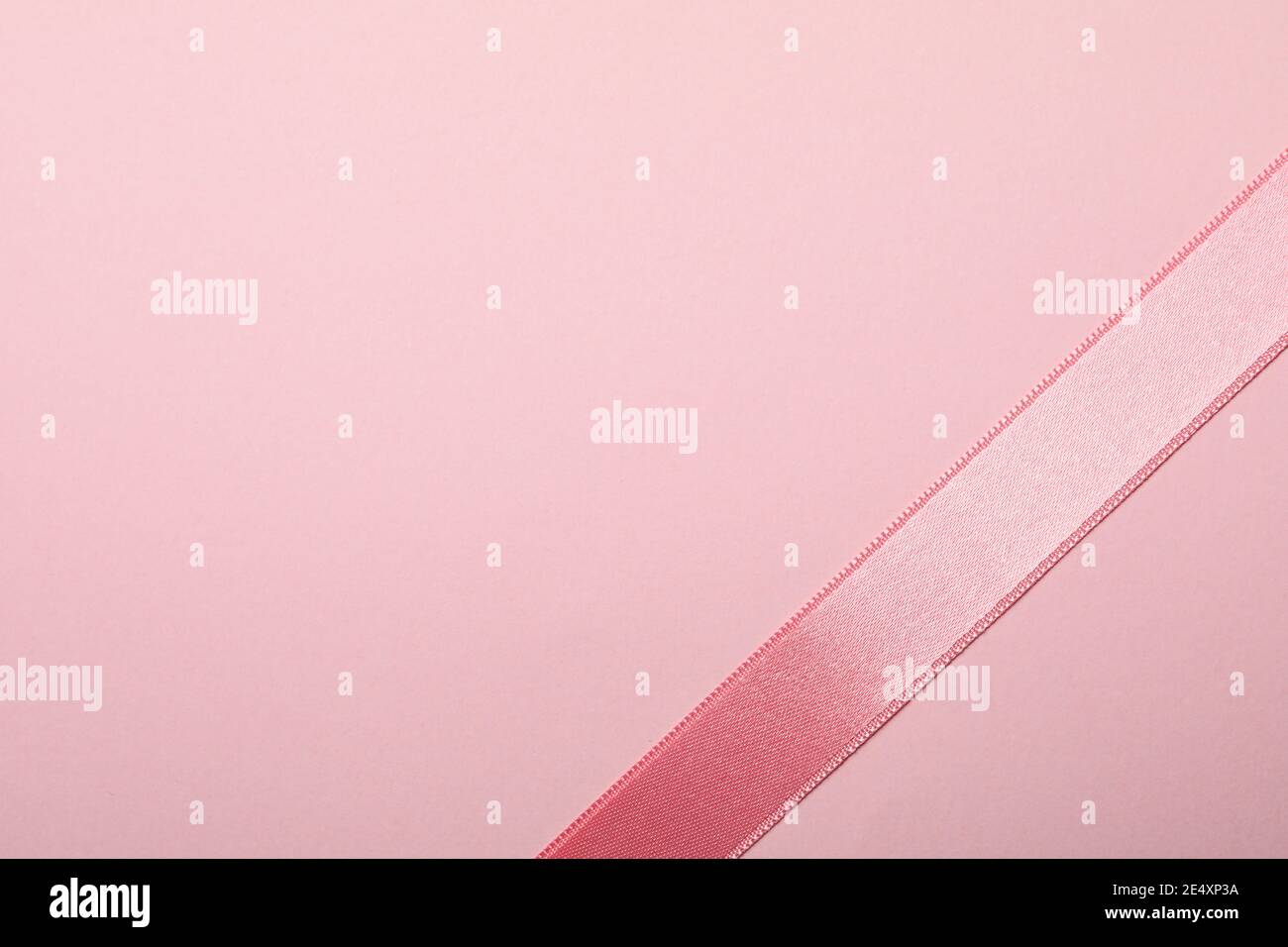 Pink satin ribbon on pink background, space for text Stock Photo - Alamy