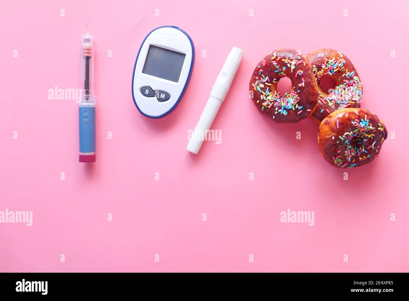 diabetic measurement tools, insulin and donuts on pink Stock Photo - Alamy