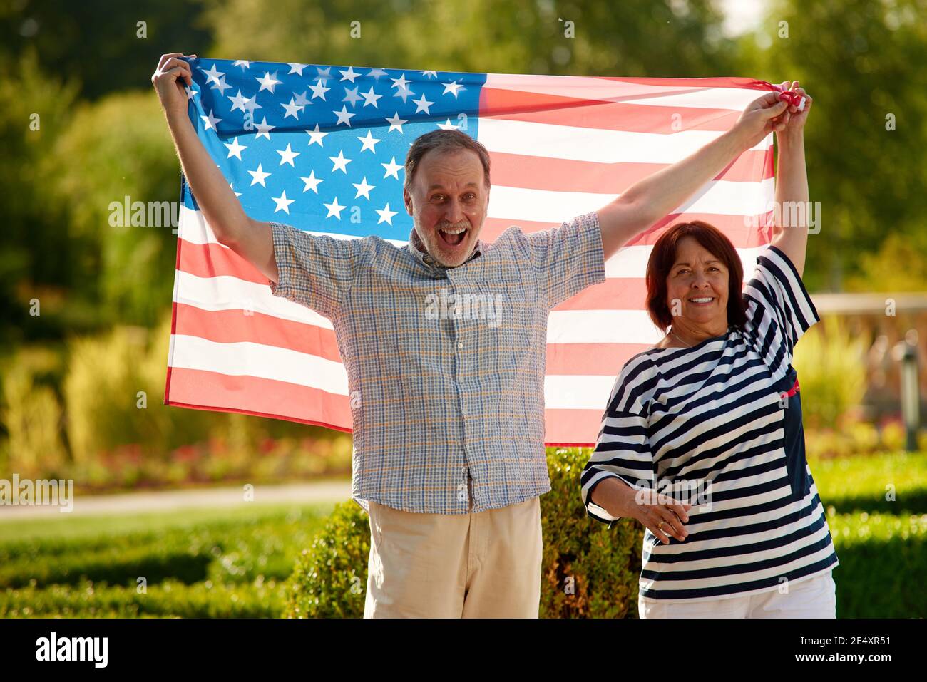 Happy mature couple holding usa flag Stock Photo - Alamy