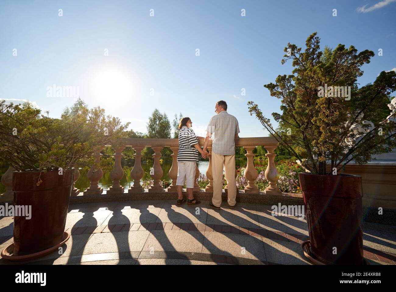 Happy couple holding hands on the balcony Stock Photo - Alamy
