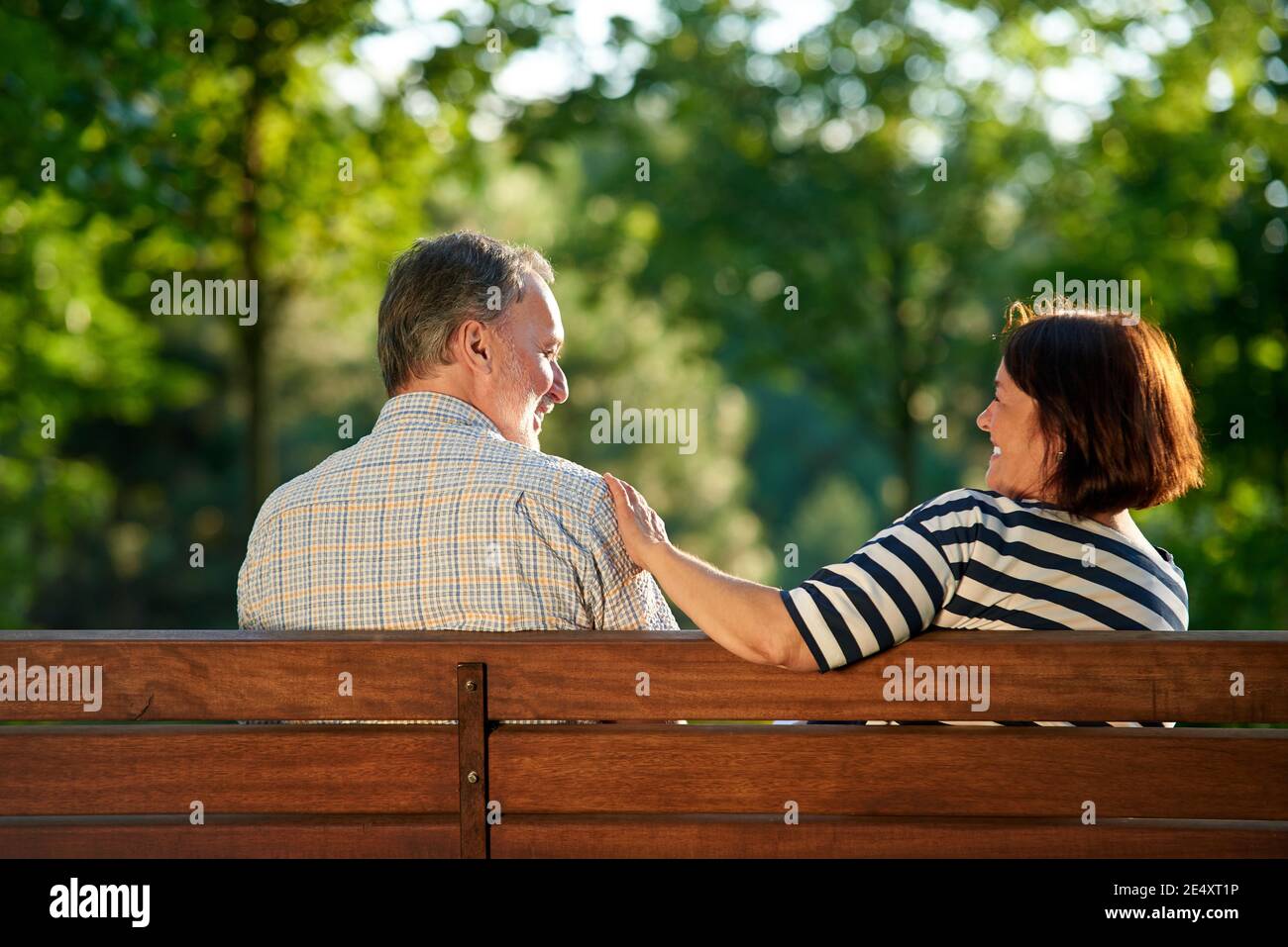 Back view happy mature couple on the bench Stock Photo - Alamy