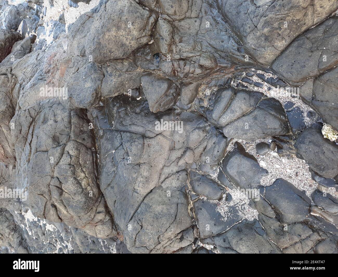 Macro closeup from scratched surface of a grey rock stone in high angle ...