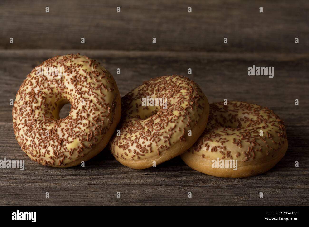 Delicious ring donuts covered with vanilla, topped with sprinkles Stock ...