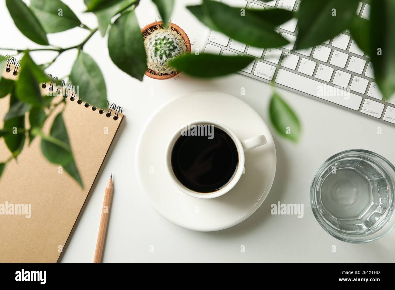 Workplace with cup of coffee on white background Stock Photo - Alamy