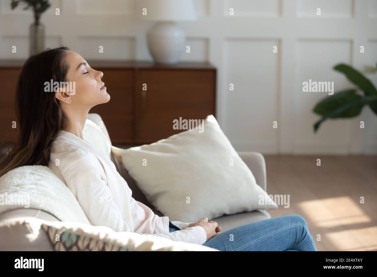 Close up calm young woman relaxing on couch at home Stock Photo - Alamy