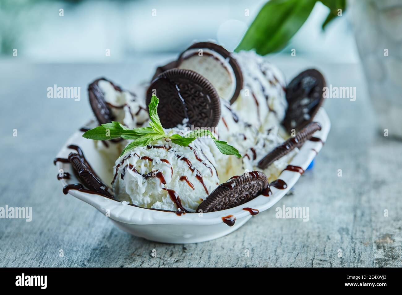 Oreo ice-cream with chocolate syrup and mint in the white plate on the ...