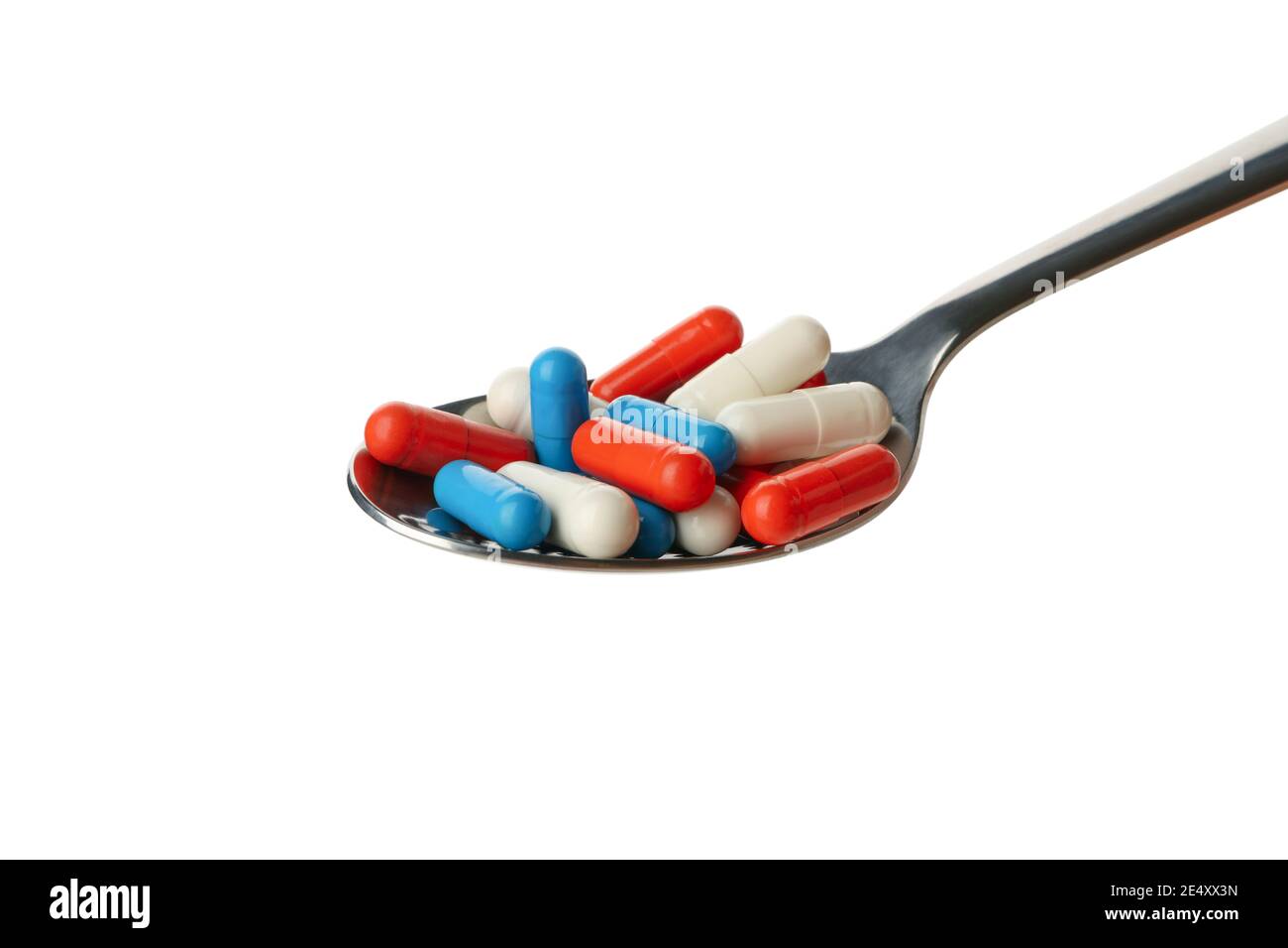 Spoon with medicine capsules isolated on white background Stock Photo ...