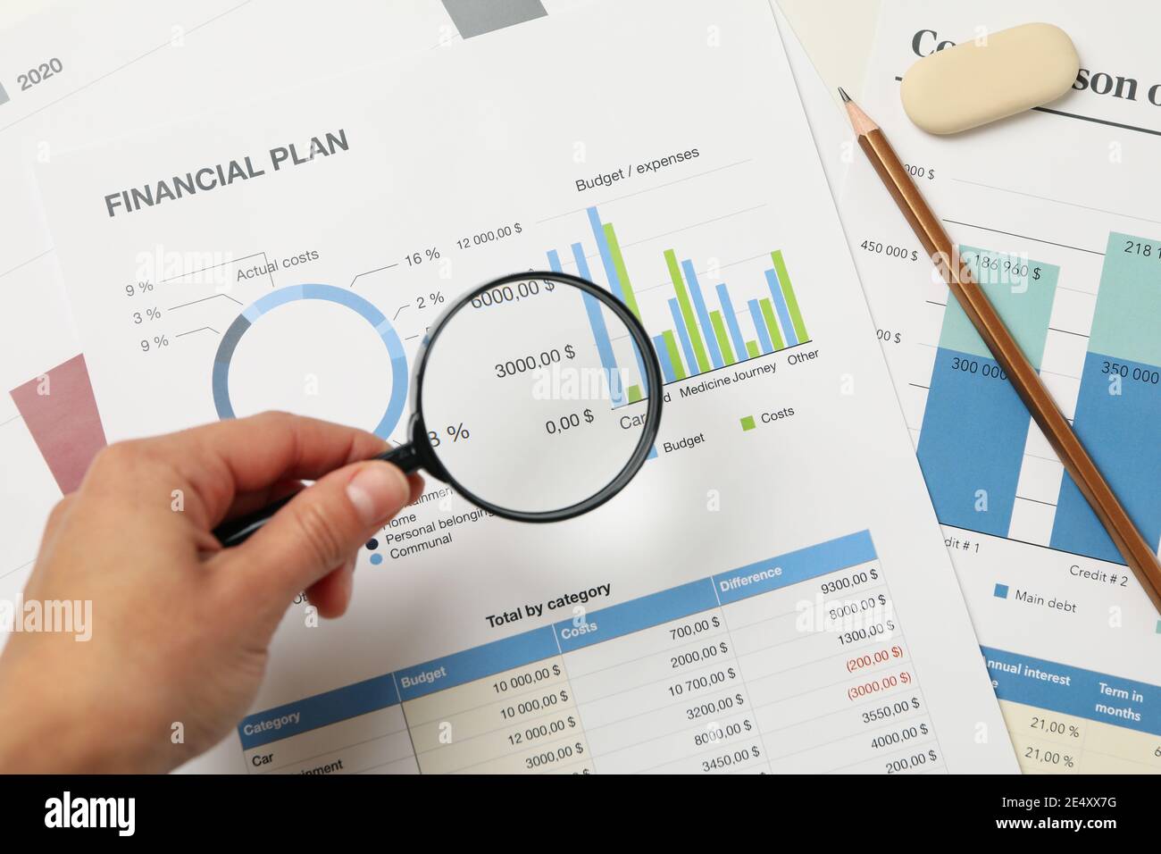 Female hand holding magnifier on financial documents background Stock ...