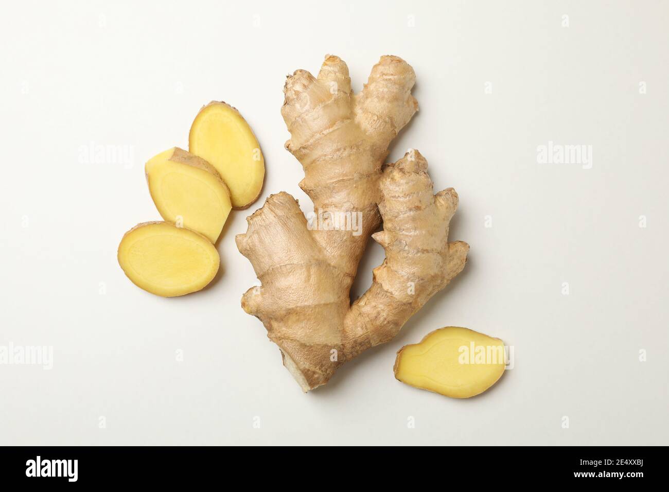 Fresh raw ginger and slices on white background Stock Photo - Alamy