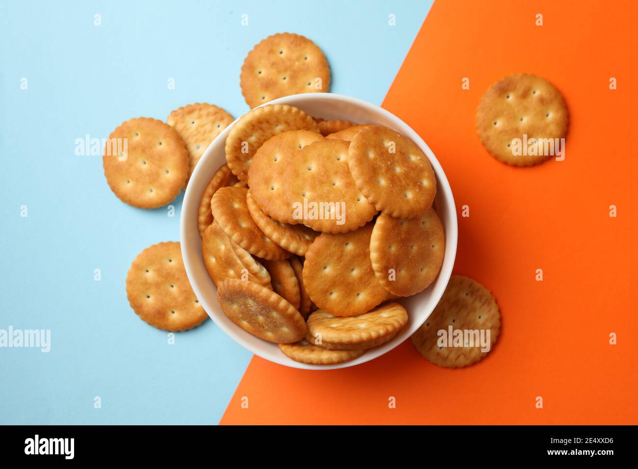 Bowl with cracker biscuits on two tone background Stock Photo - Alamy