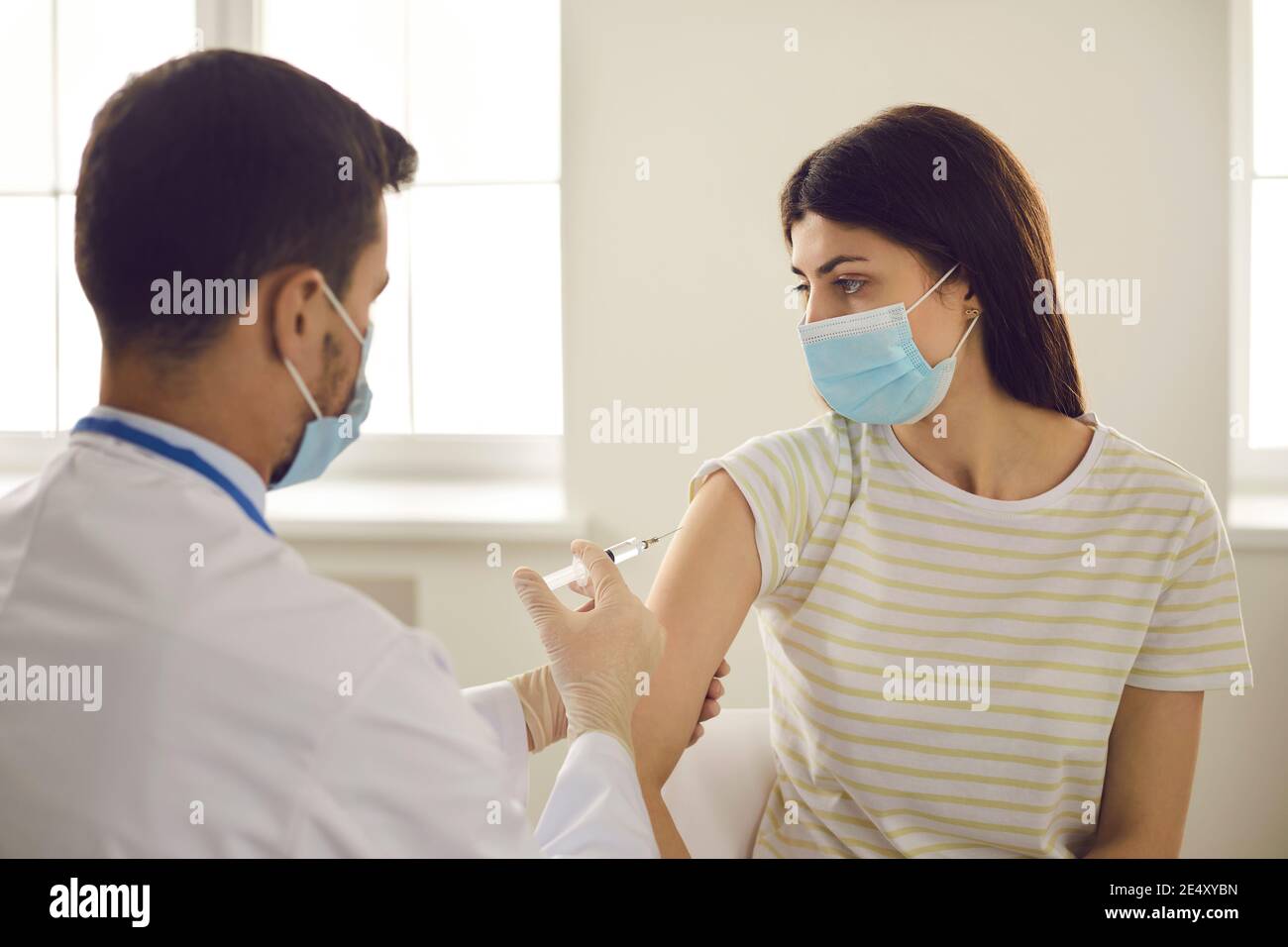 Doctor giving vaccine shot to patient during seasonal immunization ...