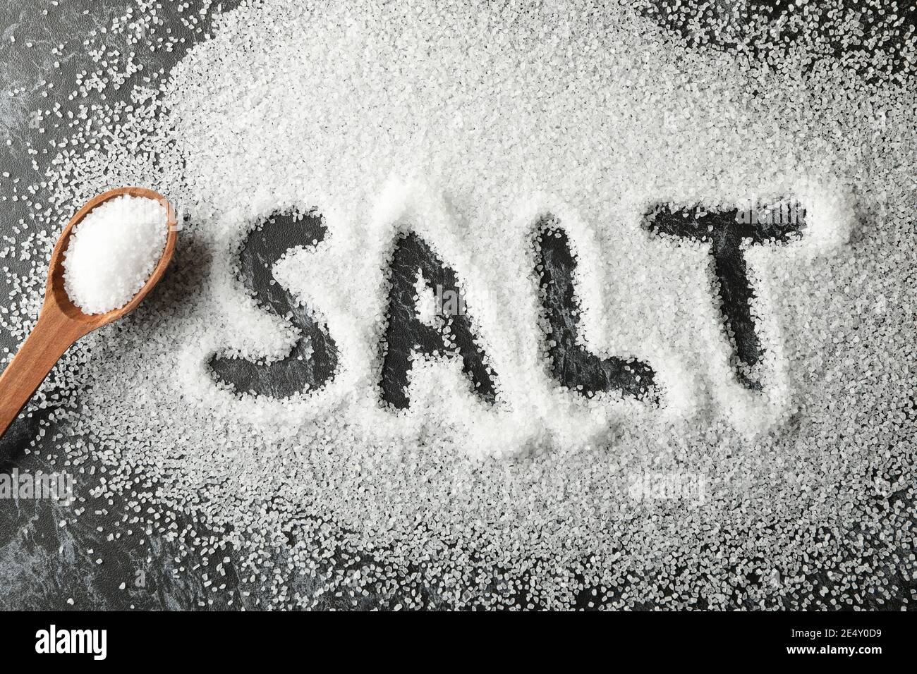 Word Salt made of sea salt and spoon on black smokey background Stock ...