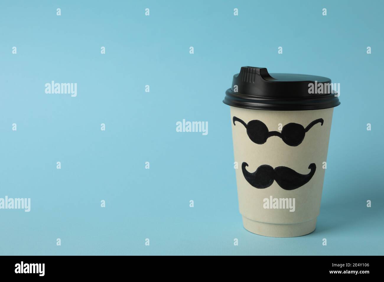 Paper cup with painted mustaches and glasses on blue background Stock ...