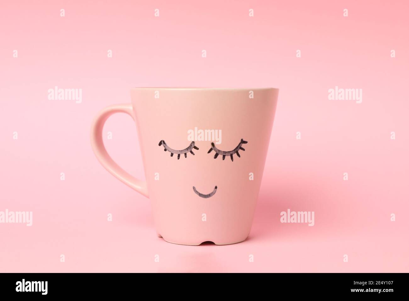 Cup with happy face on pink background Stock Photo - Alamy