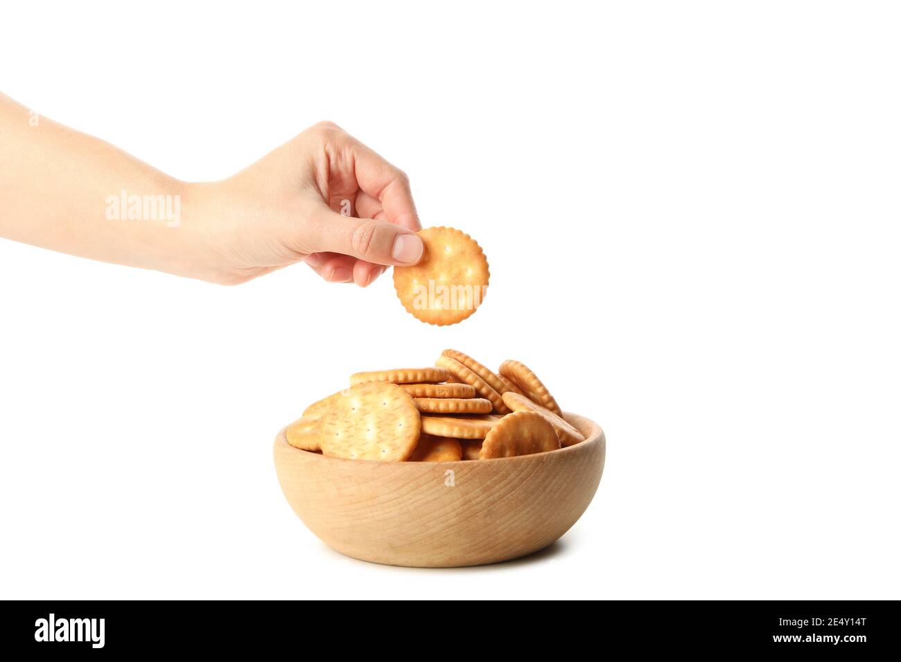 Wooden bowl with cracker biscuits and female hand holds cracker ...