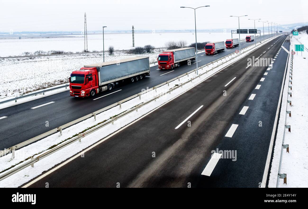 Highway transportation with a convoy of Lorry trucks passing trucks in ...